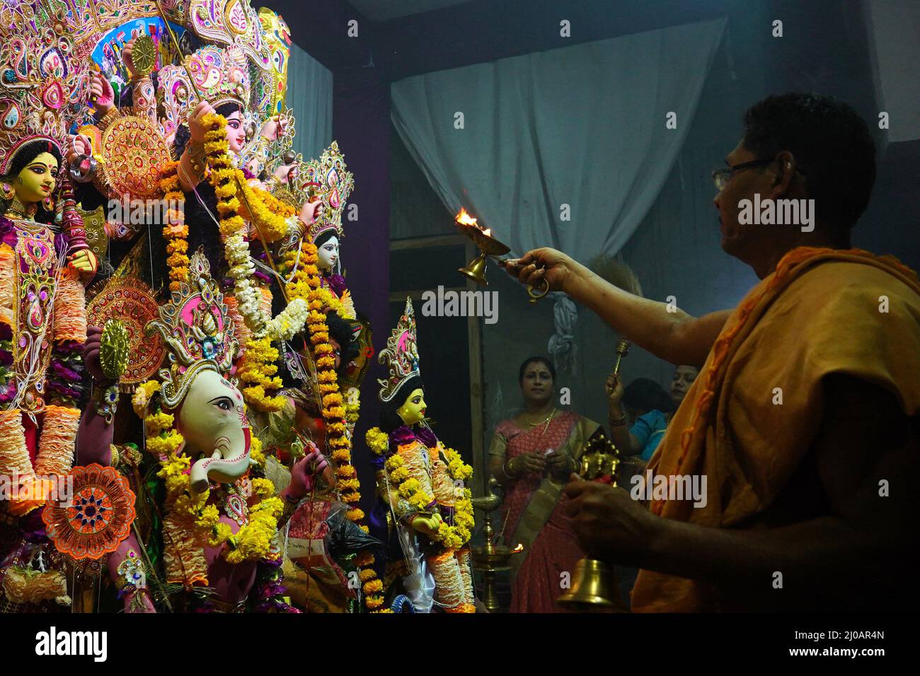 Indian People Perform Rituals in front of an idol of the Goddess Durga ...