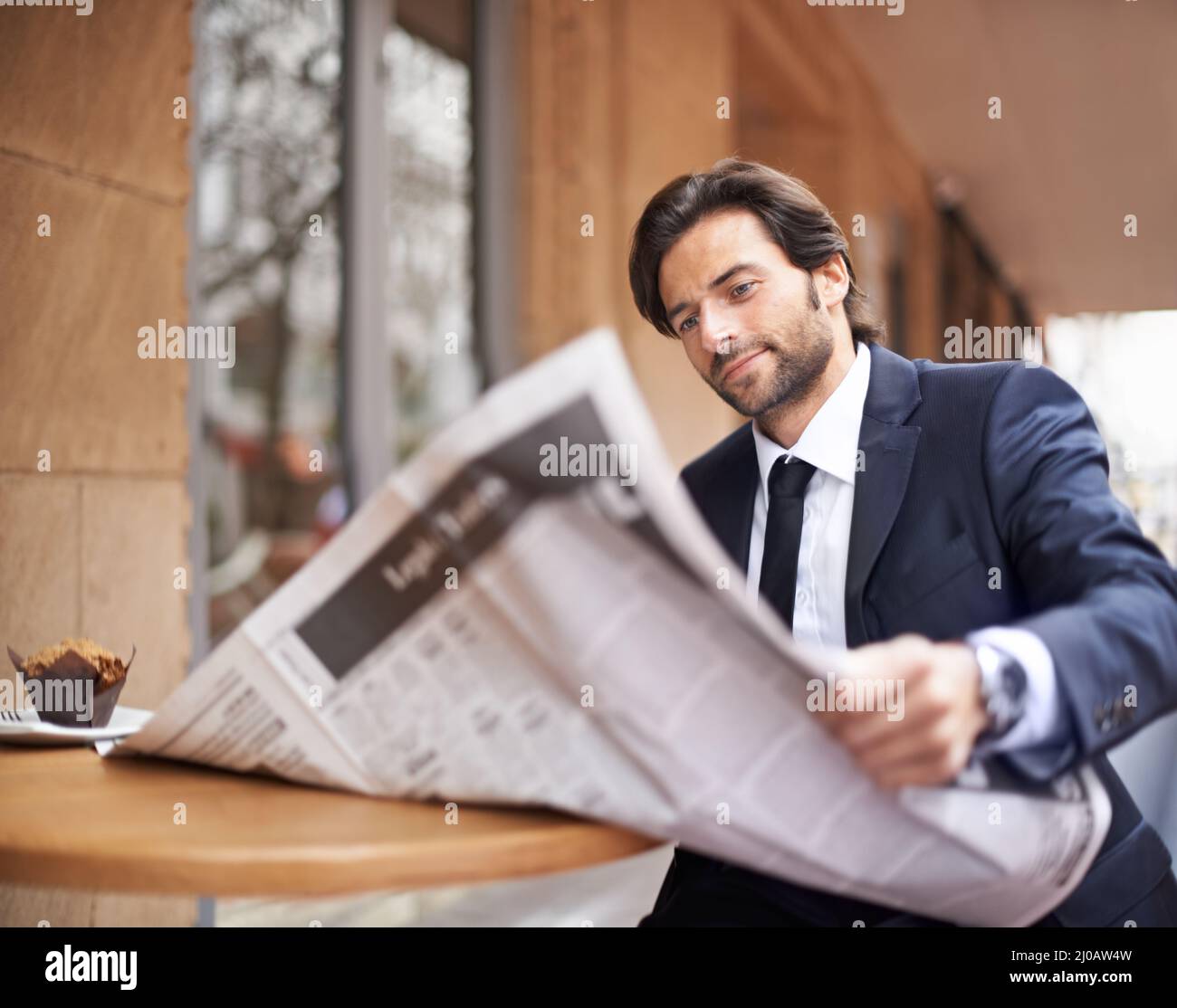 Straight to the business section. A young businessman reading a ...