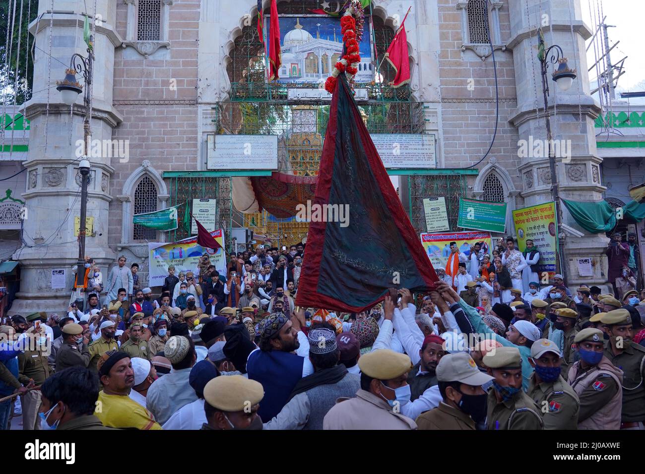 An Indian Muslim devotee takes part in the flag hoisting ceremony ...