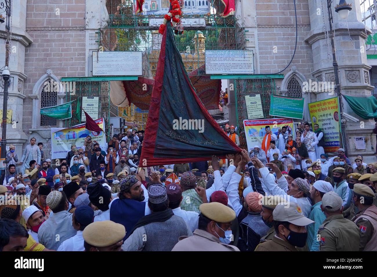 An Indian Muslim devotee takes part in the flag hoisting ceremony ...