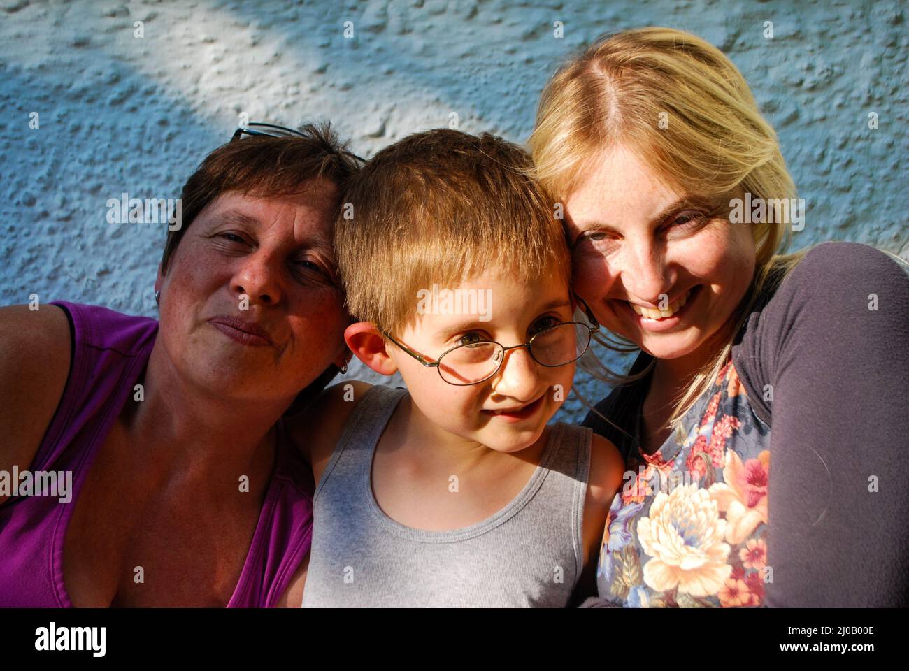 A woman poses with her children for a picture Stock Photo - Alamy