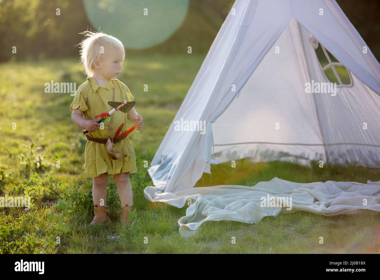 Cute portrait of native american boys with costumes, playing outdoor in ...