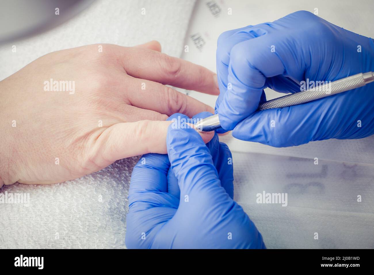 Finger nail treatment, grinding and polishing in beauty salon. Manicure ...