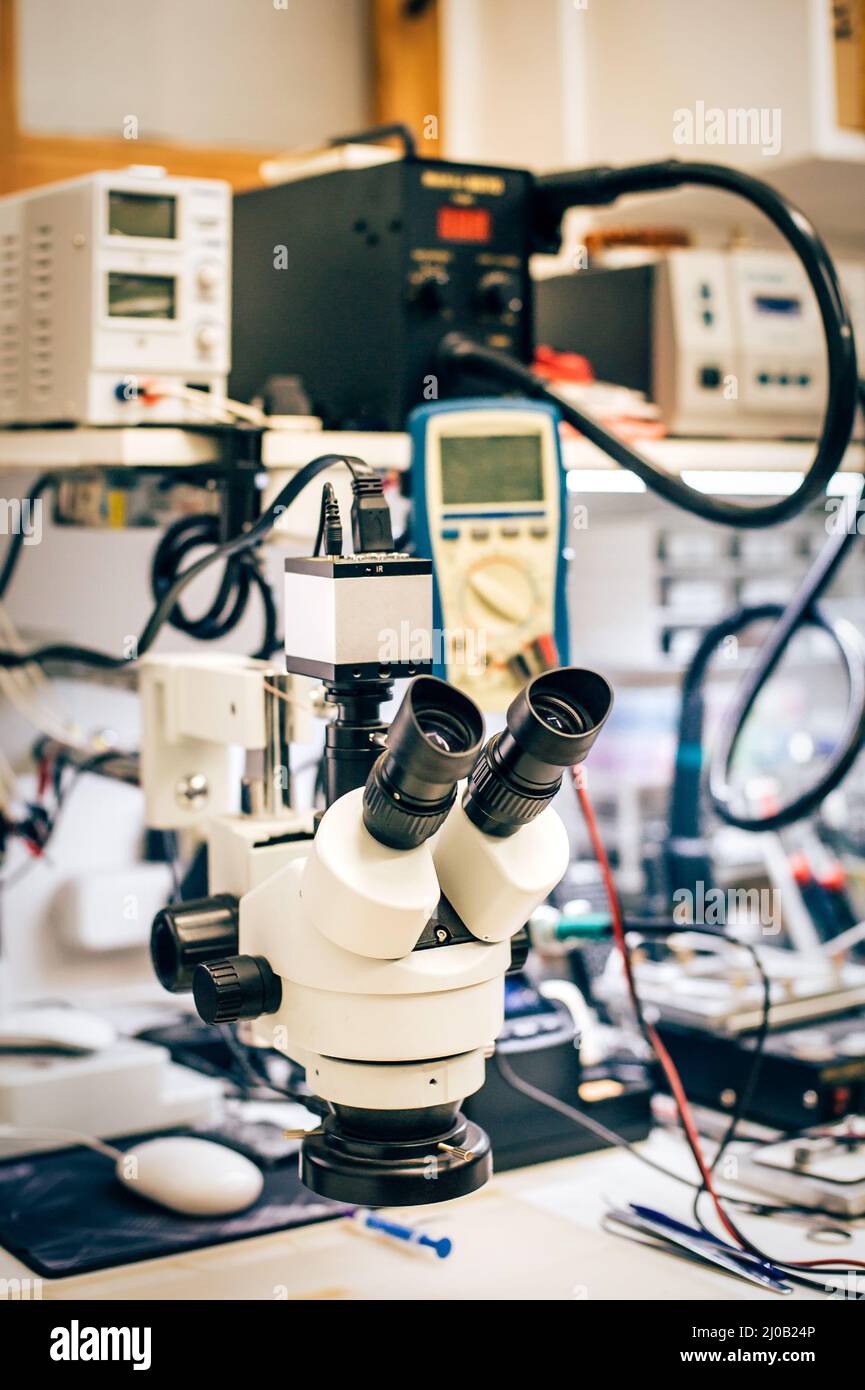 Microscope for detail macro view of faulty microchip and motherboard in ...
