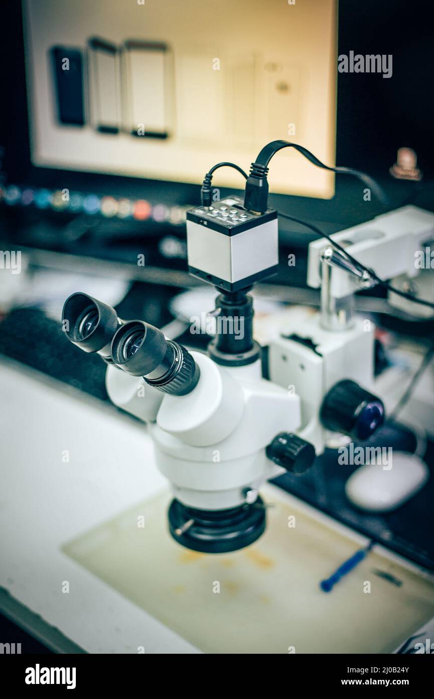 Microscope for detail macro view of faulty microchip and motherboard in ...