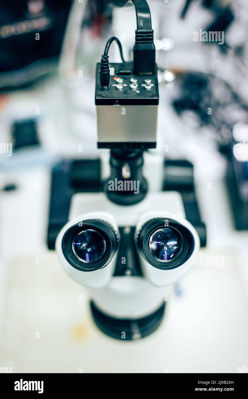 Microscope for detail macro view of faulty microchip and motherboard in ...