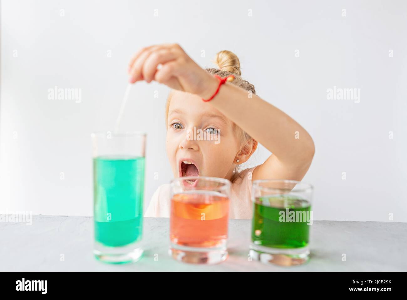 cute little girl six years old doing laboratory experiment with ...
