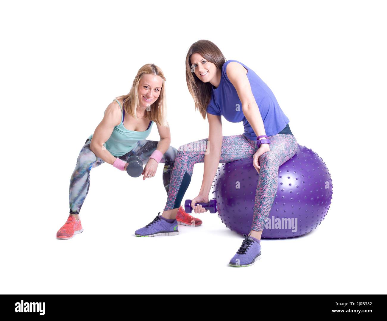 Two sport woman exercise with a pilates ball and dumbbells Stock Photo ...