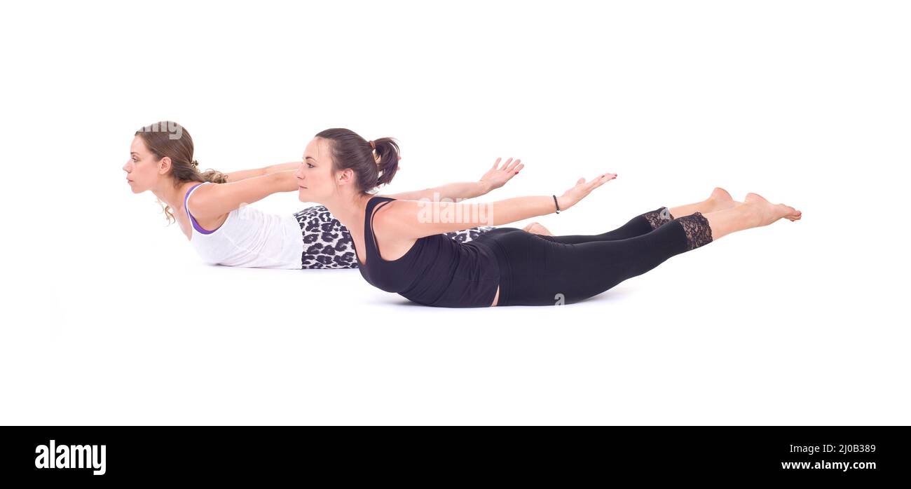 Practicing Yoga exercises in group / Locust Pose - Salabhasana Stock ...