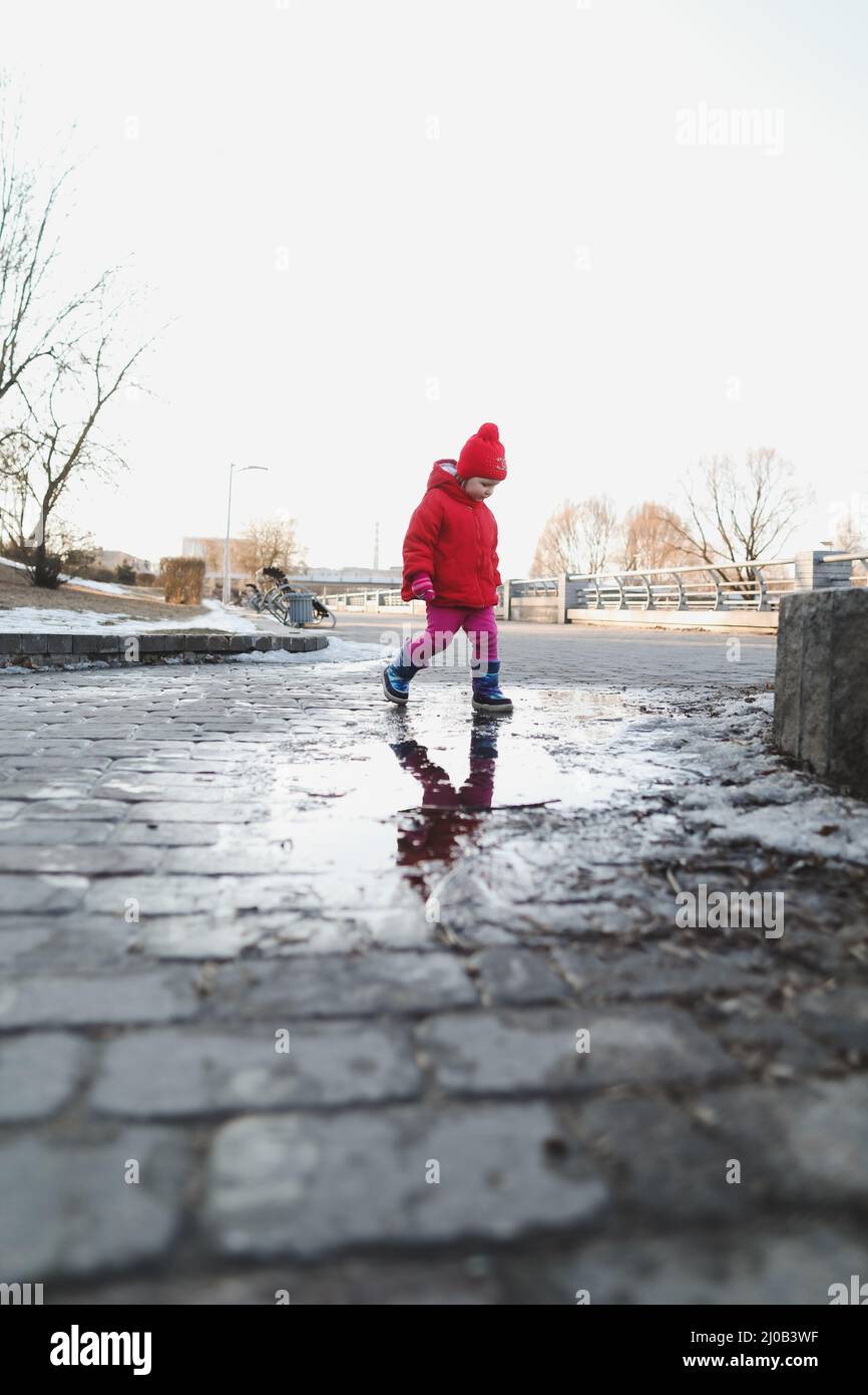 Kid child jumping puddle water splash hi-res stock photography and ...