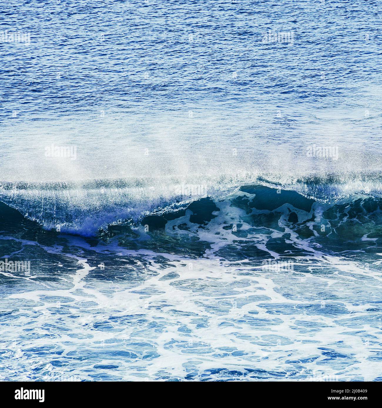 Swirled blue colored ocean wave Stock Photo - Alamy