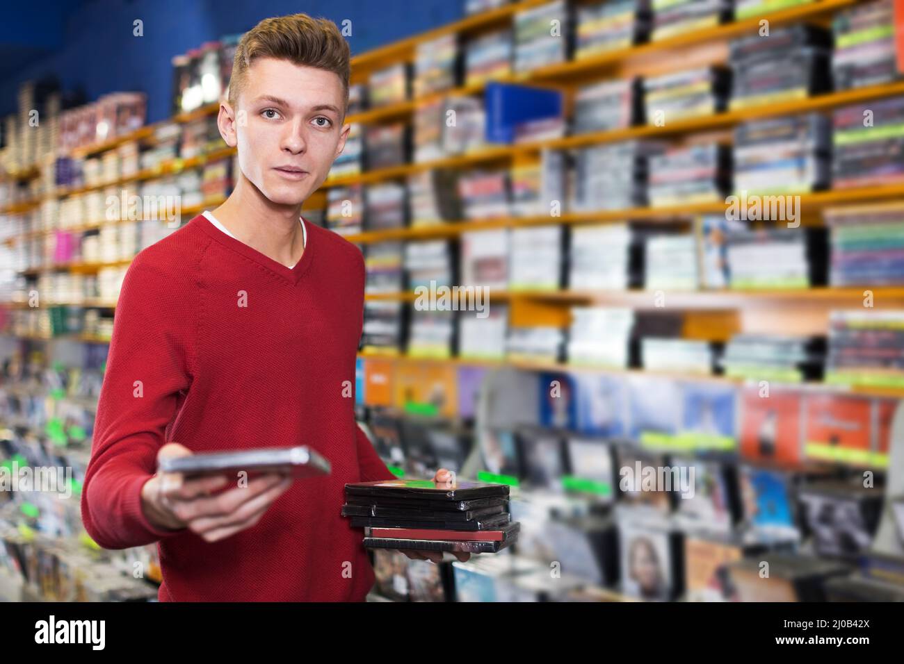 Guy holding CD in shop Stock Photo - Alamy