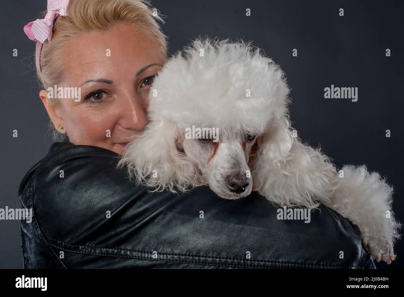 Portrait of a beautiful young woman hugging her beautiful dog. Small ...