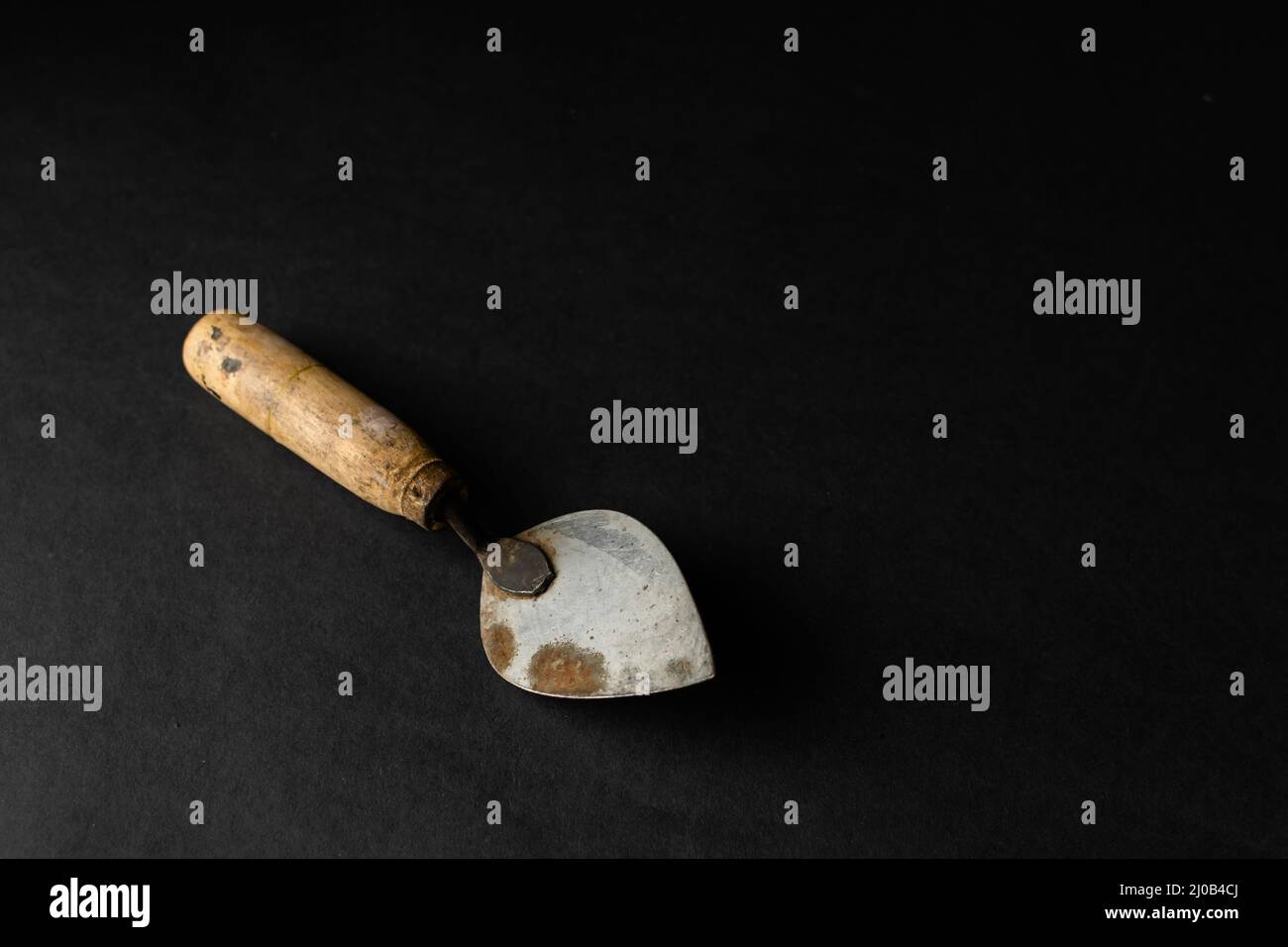Trowel on black background with copy space and used selective focus ...