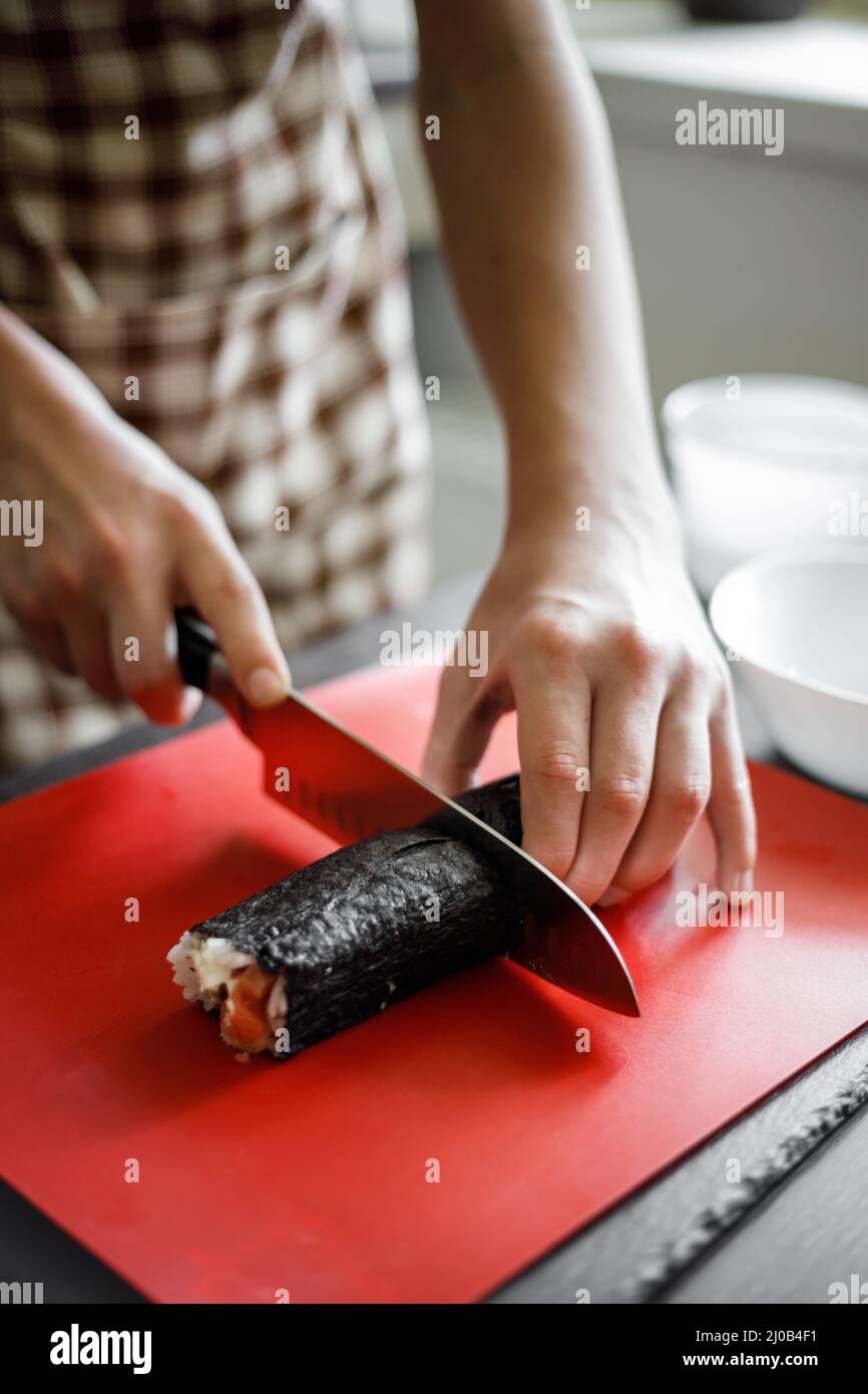 Young boy making sushi roll hi-res stock photography and images - Alamy