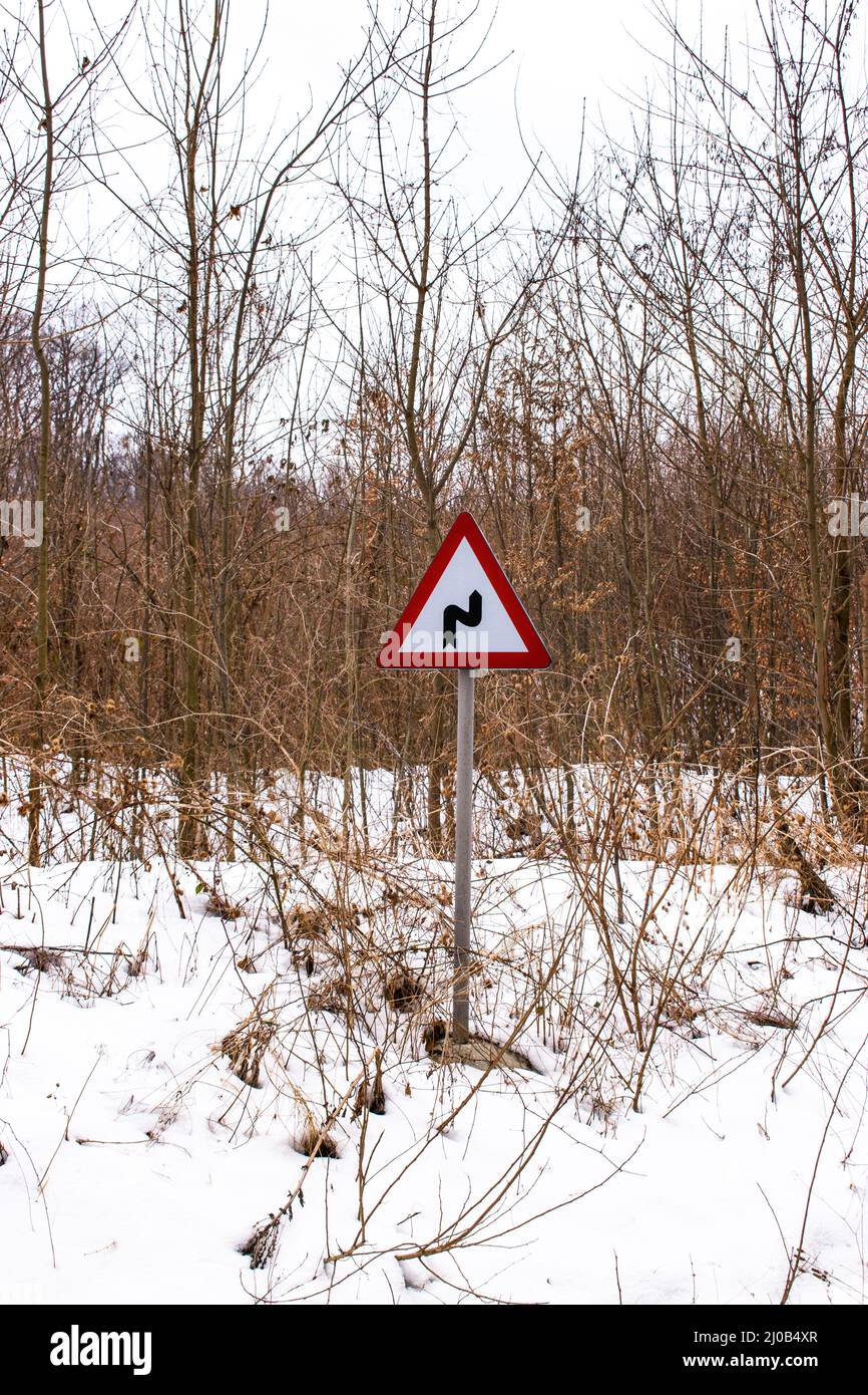 Vertical shot of a warning reverse curve or double curve traffic sign ...