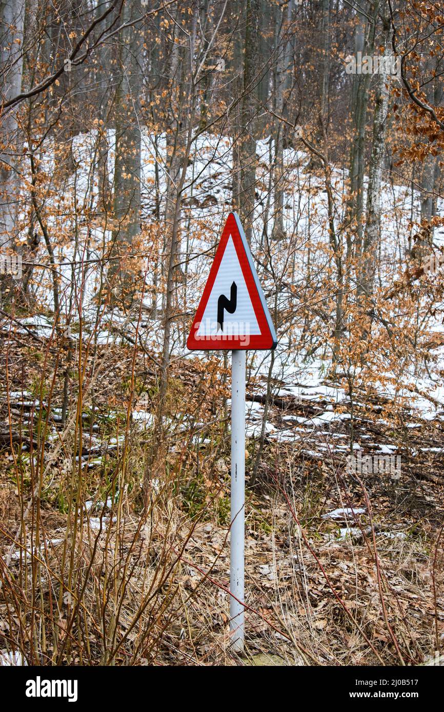 Vertical shot of a warning reverse curve or double curve traffic sign ...