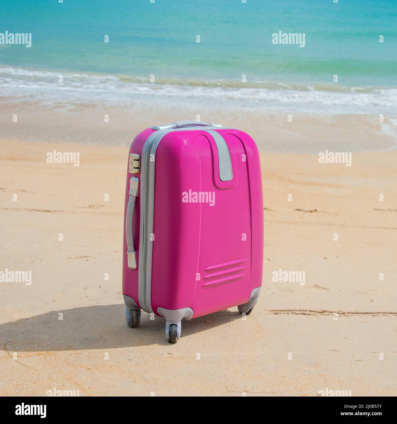 Suitcase at the beach Stock Photo - Alamy