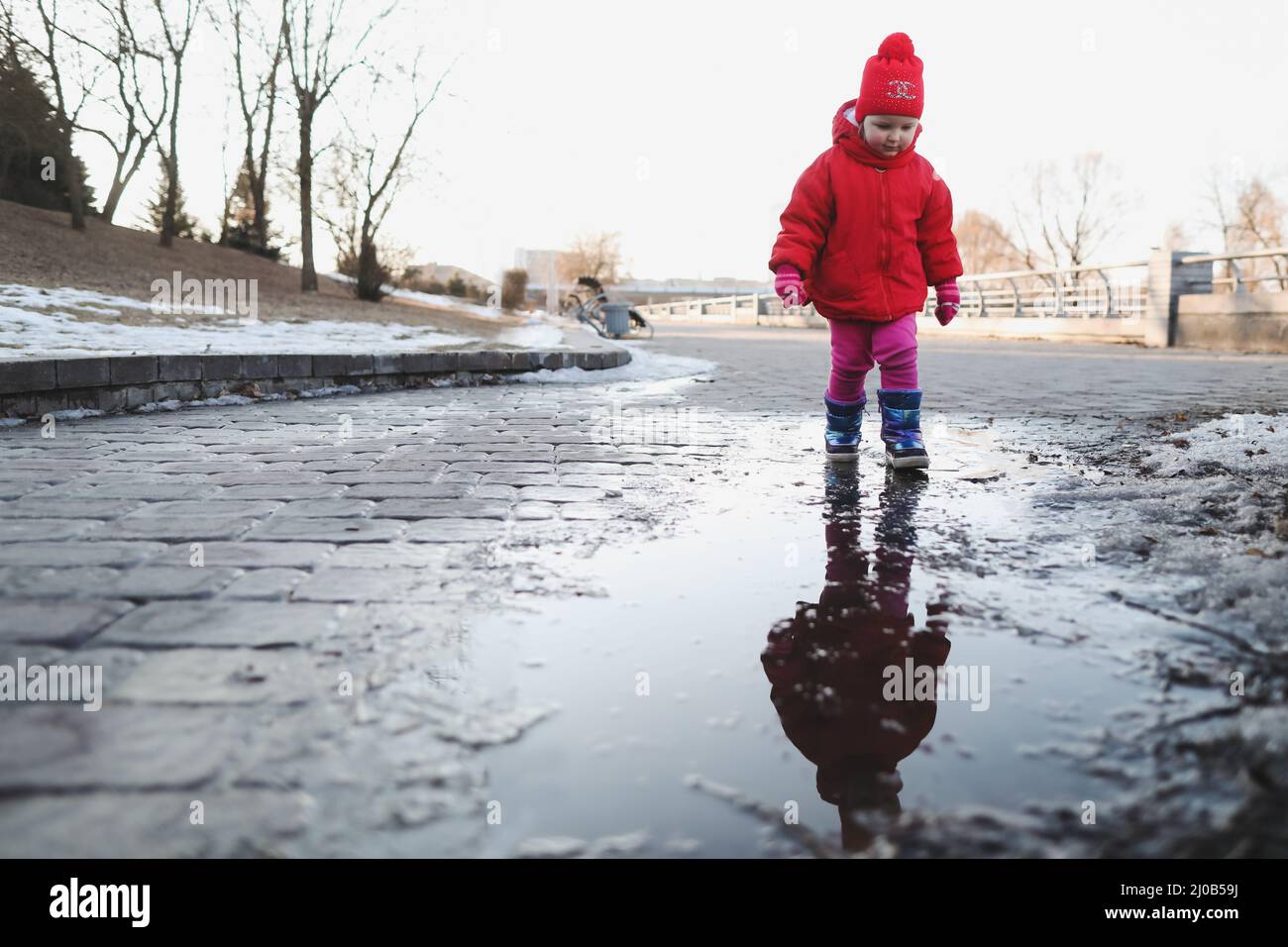 Kid child jumping puddle water splash hi-res stock photography and ...