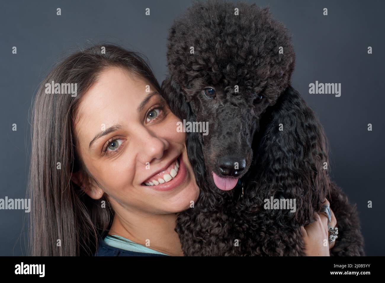 Portrait of a beautiful young woman hugging her beautiful dog. Big ...