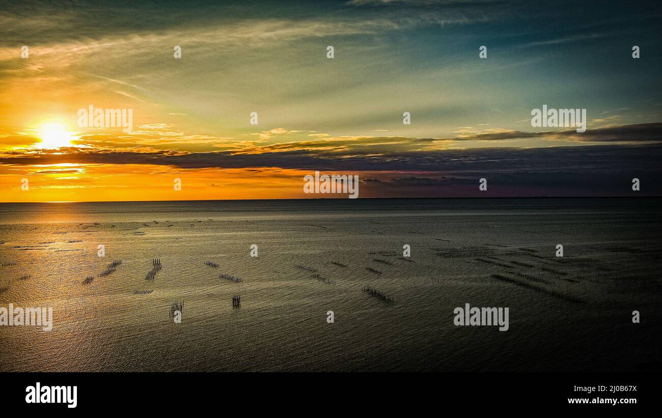 Serene landscape of a golden sunset on the sandy beach of Bang Sean Sea ...