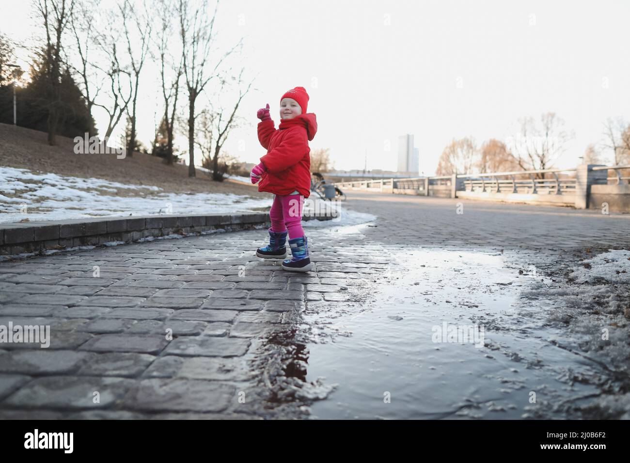 Kid child jumping puddle water splash hi-res stock photography and ...