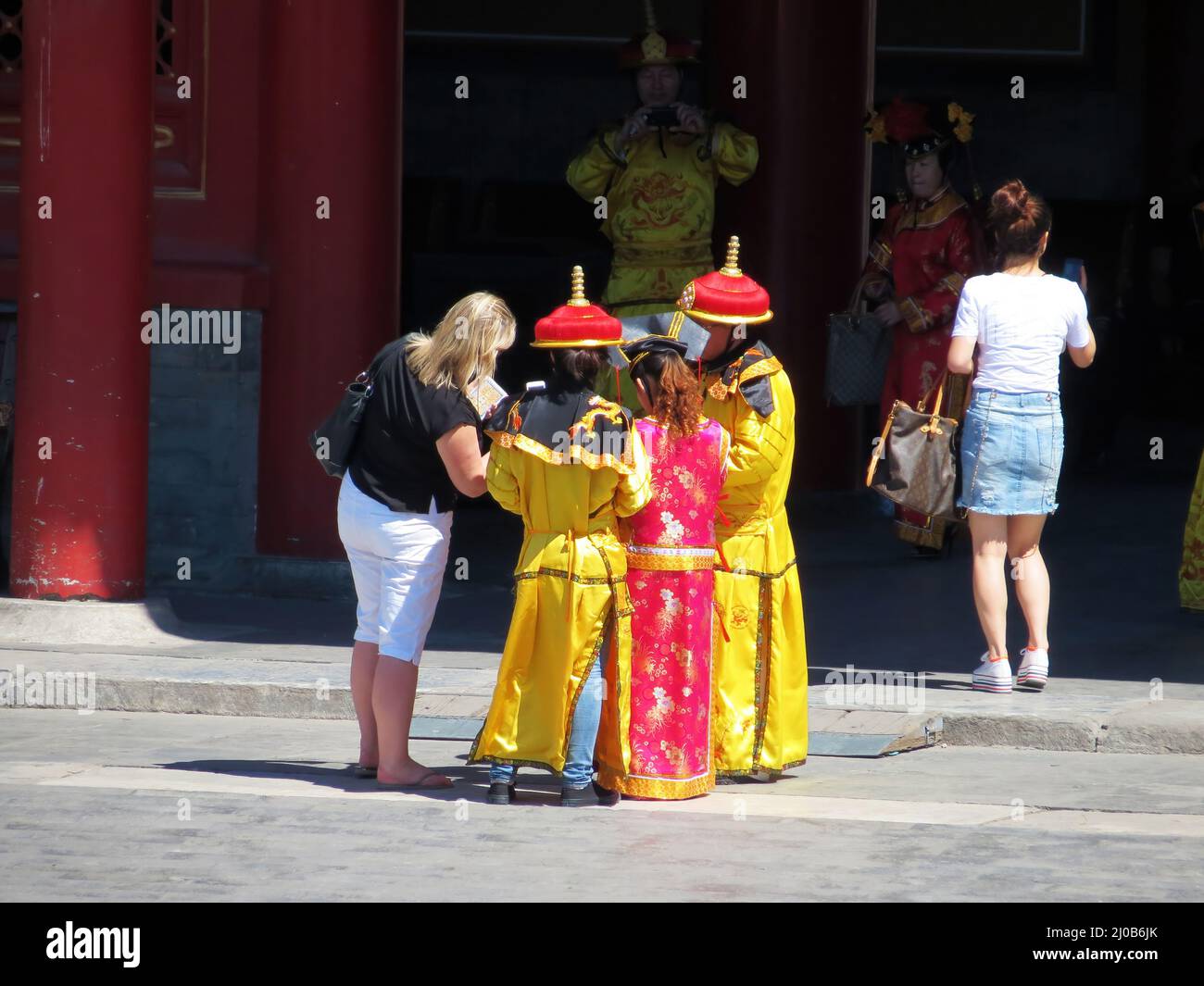 The visitors dress up as emperors in The Forbidden City in Beijing ...