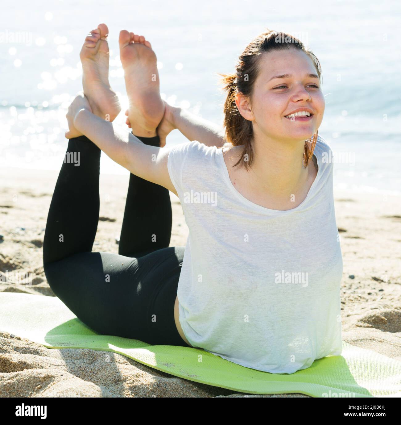 Female 20-30 years old is practicing asana in white T-shirt Stock Photo ...