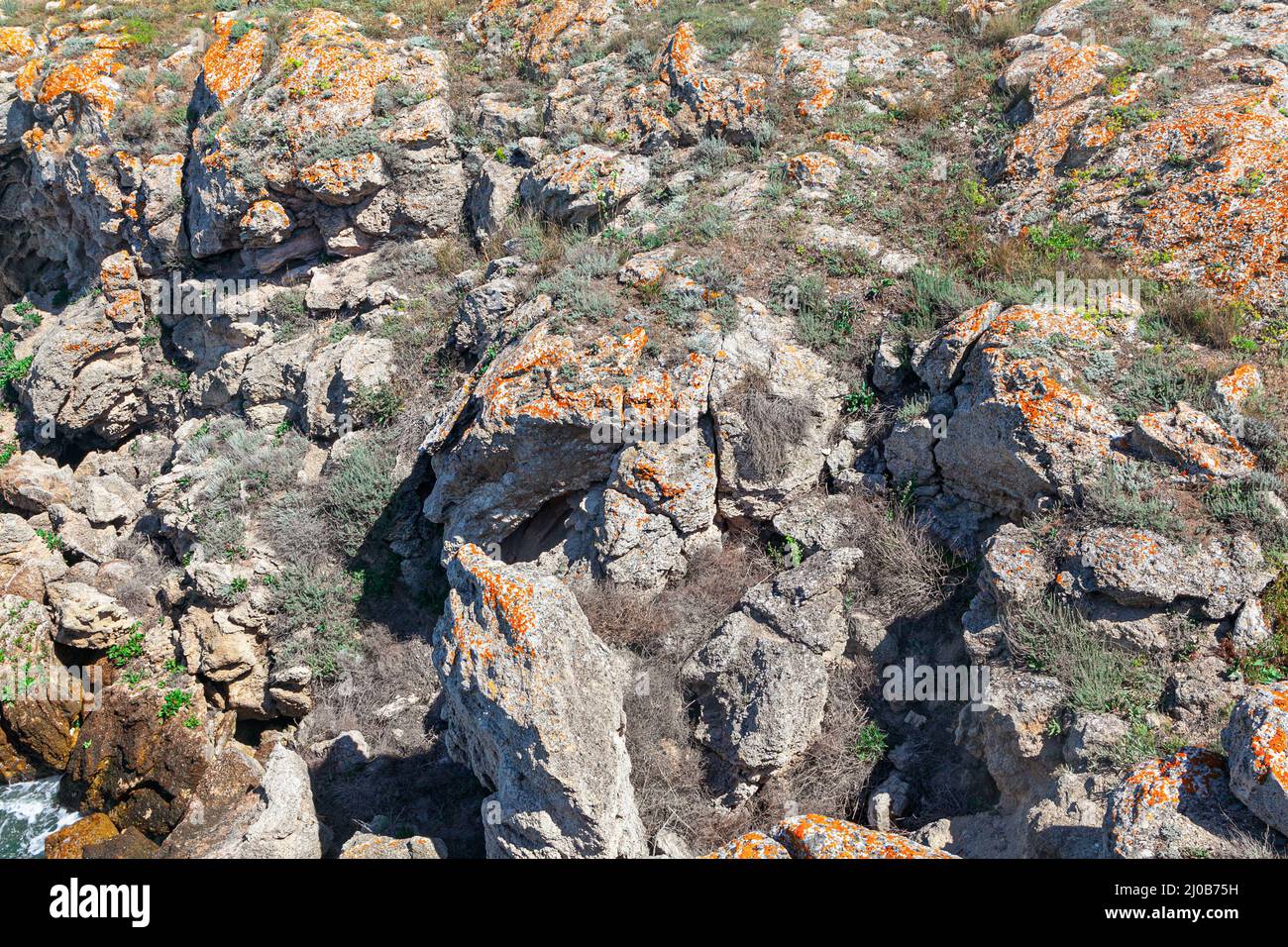 Rocky land background . Rocks of coastal mountain Stock Photo - Alamy