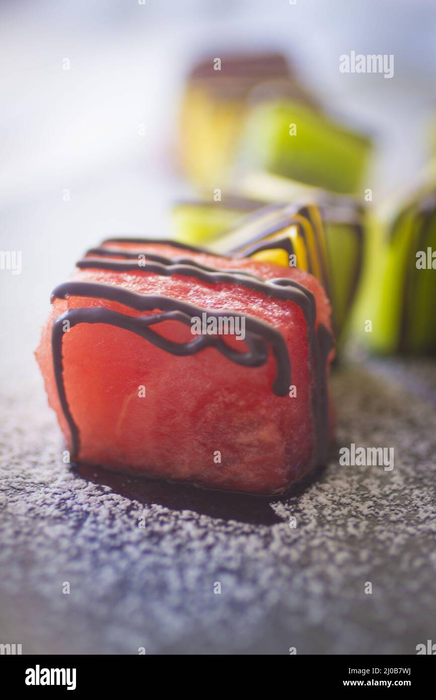 Watermelon melon and pineapple chocolate coated dessert Stock Photo - Alamy