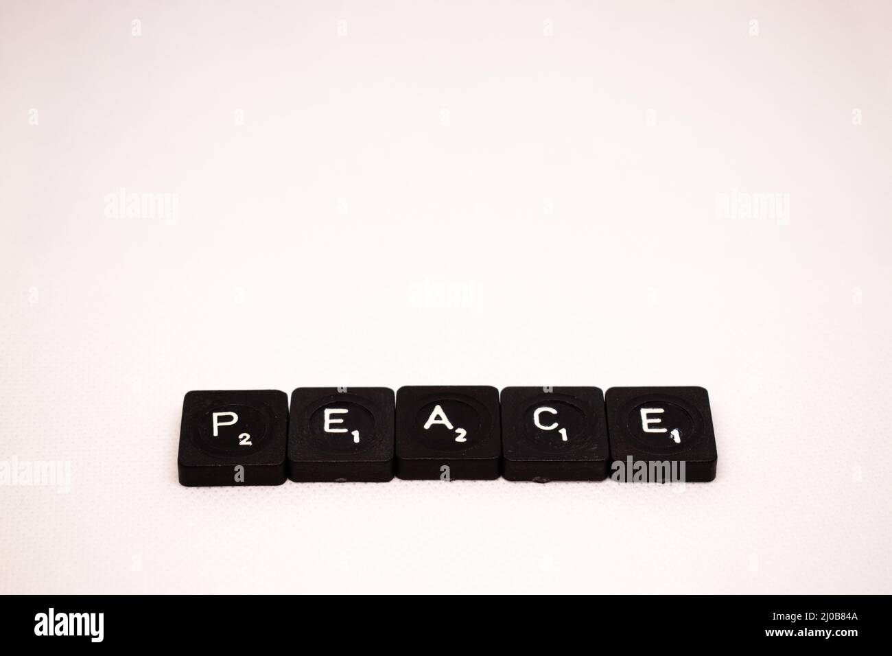 Word Peace laid out from the keyboard keys isolated on cream color ...