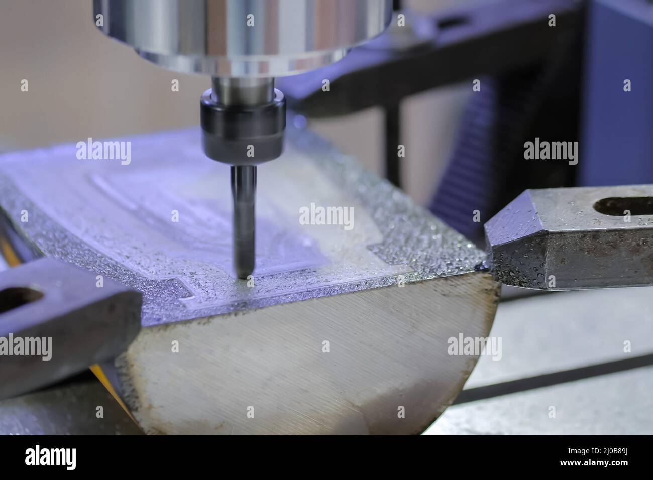 Turning milling machine cutting metal workpiece at factory - close up ...