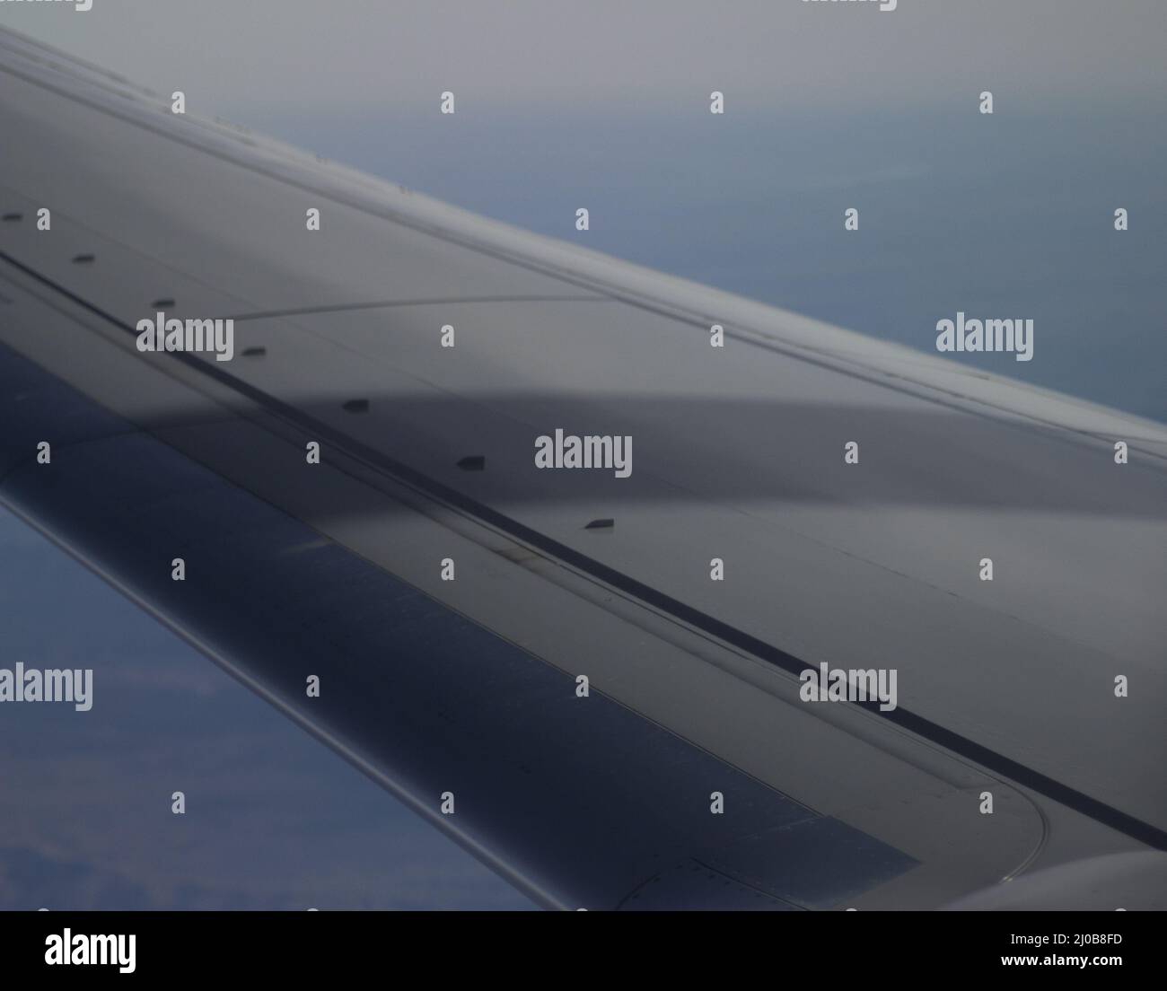 Airplane flying in sky wing in flight Stock Photo - Alamy