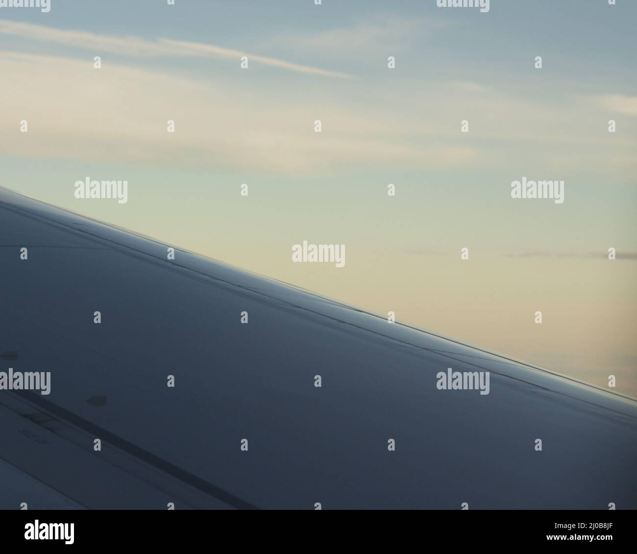 Airplane flying in sky wing in flight Stock Photo - Alamy