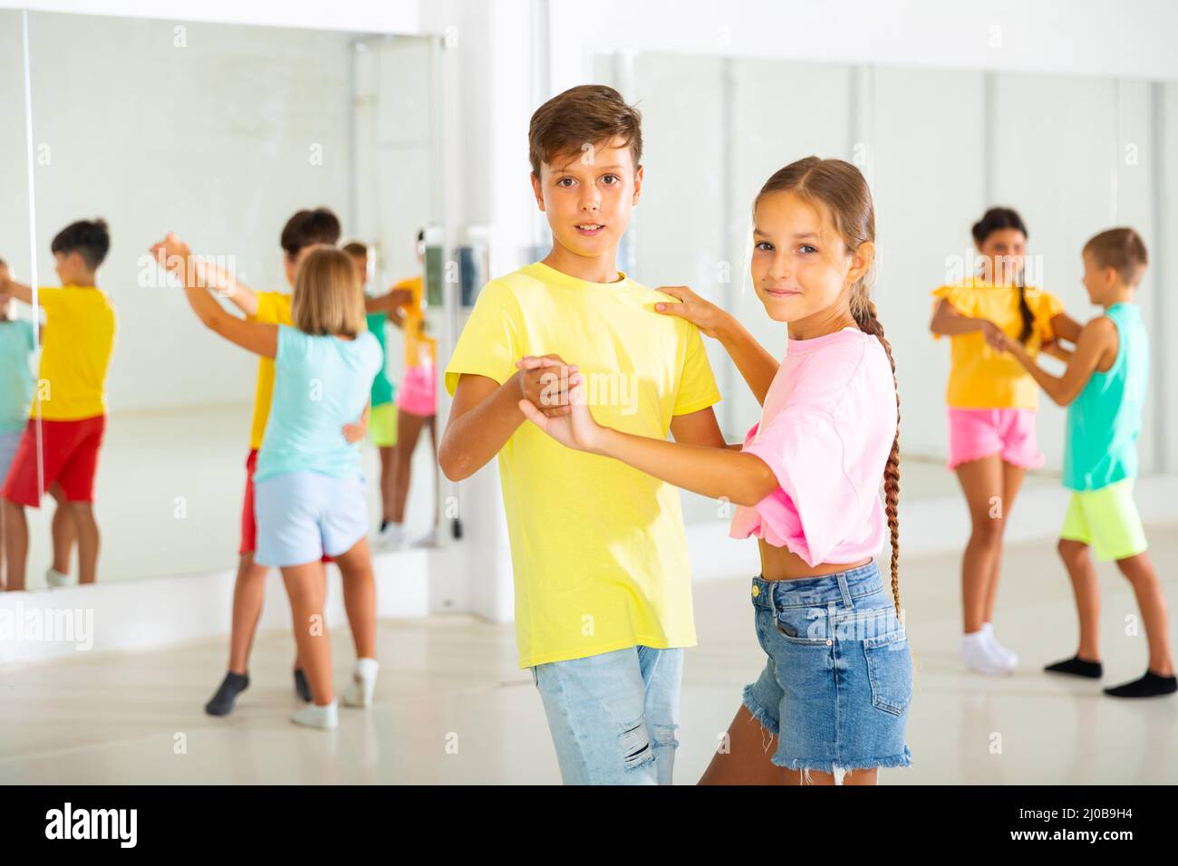 Tweenagers practicing slow ballroom dances in pairs in choreographic ...