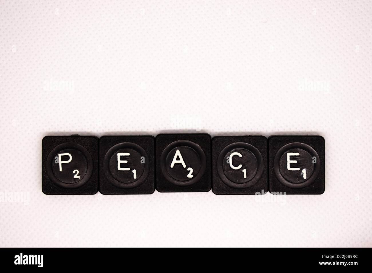 Word Peace laid out from the keyboard keys isolated on cream color ...