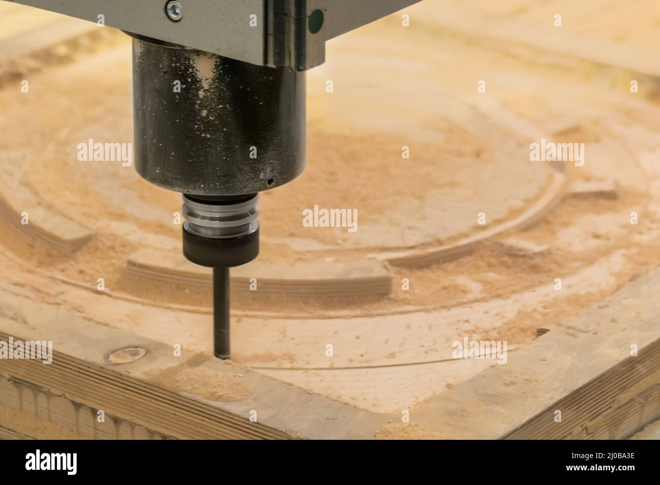 Milling machine cutting wooden workpiece from wood pulp at technology ...