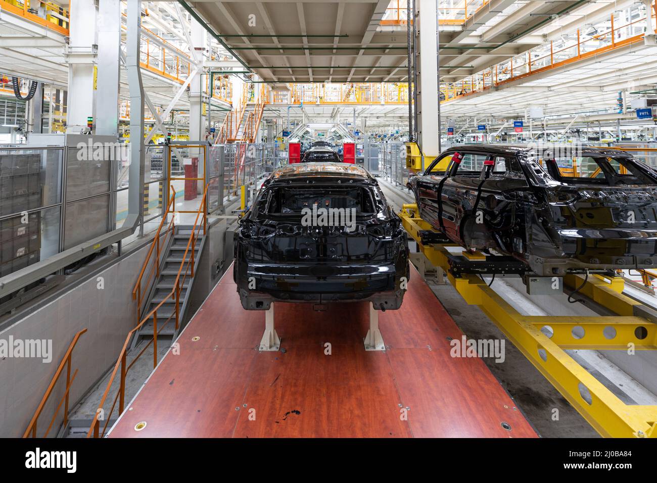 Car bodies are on assembly line. Factory for production of cars. Modern ...
