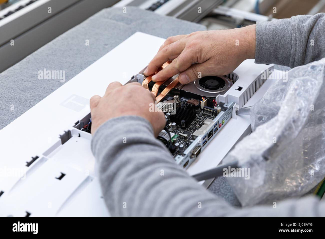 Minsk, Belarus - Dec 15, 2021: Photo of hands of a man who assembles a ...