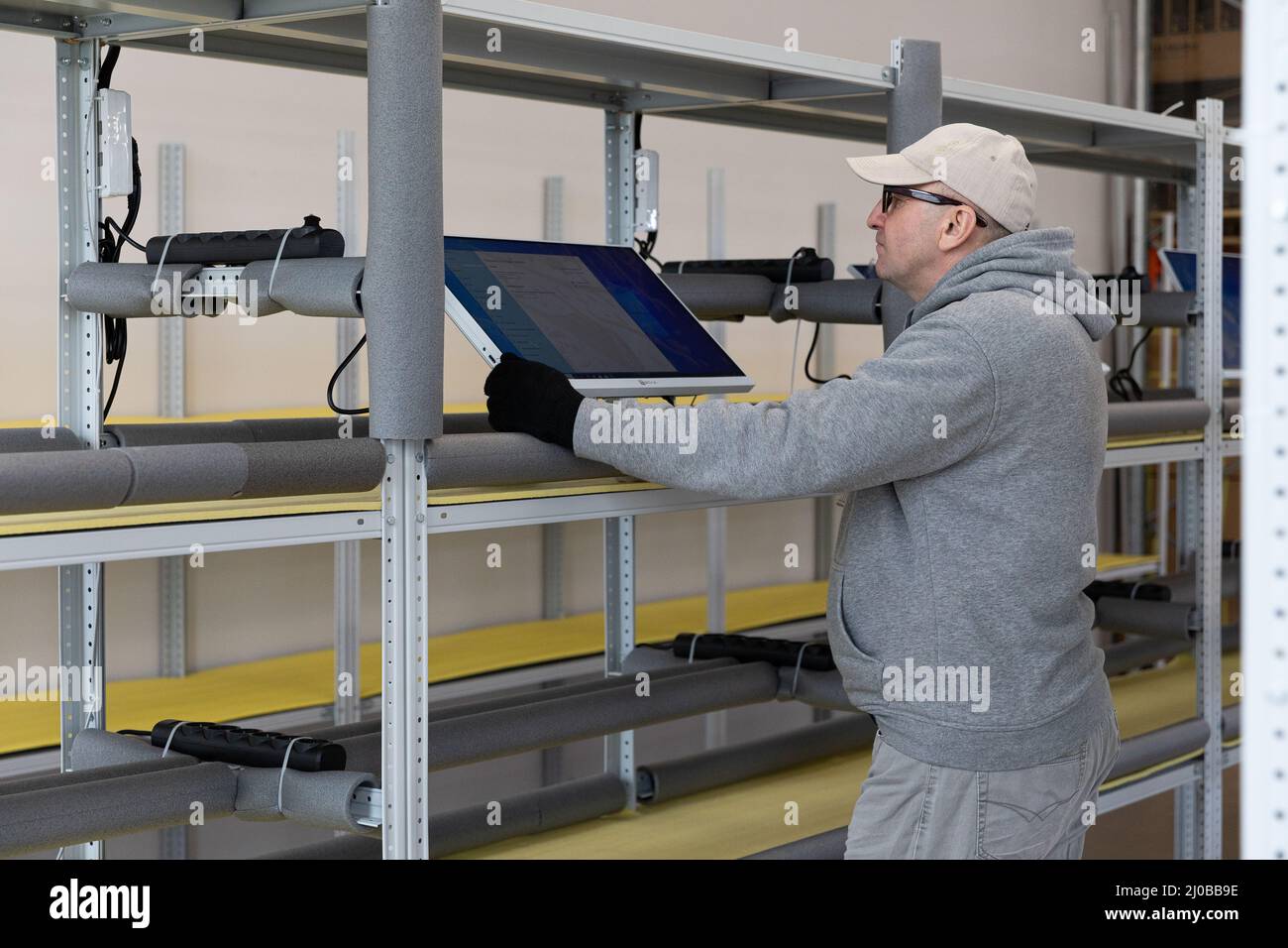 Minsk, Belarus - Dec 15, 2021: Photo of a man in a gray suit checking ...