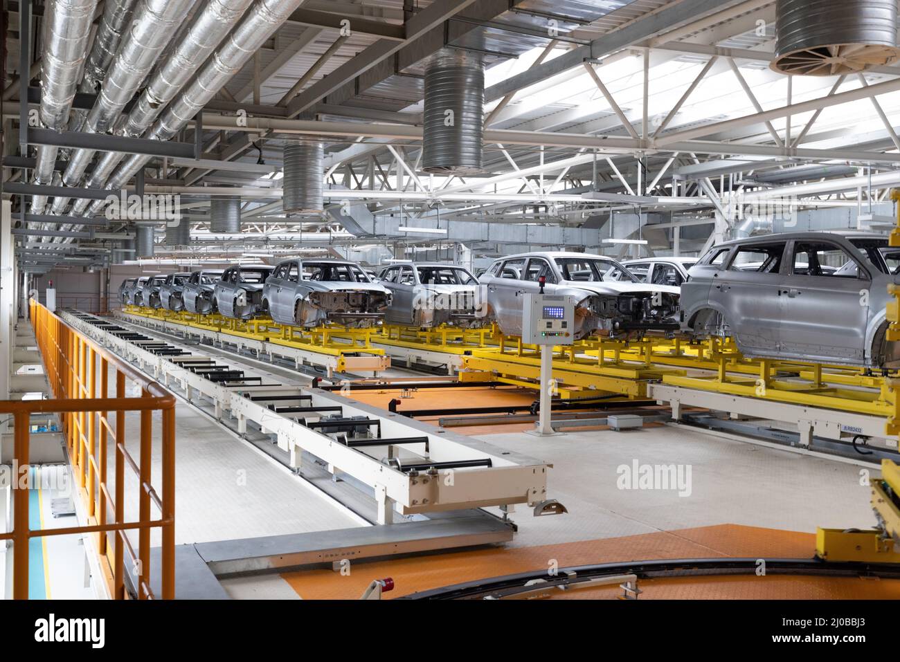 Car bodies are on assembly line. Factory for production of cars. Modern ...
