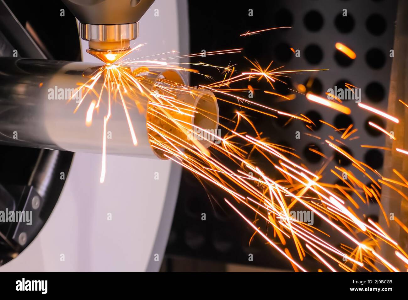 Laser cutting machine working with cylindrical metal workpiece with ...