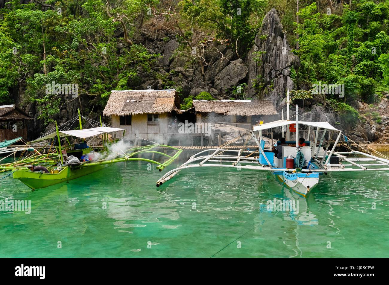 Man on stilts in sea with boat hi-res stock photography and images - Alamy