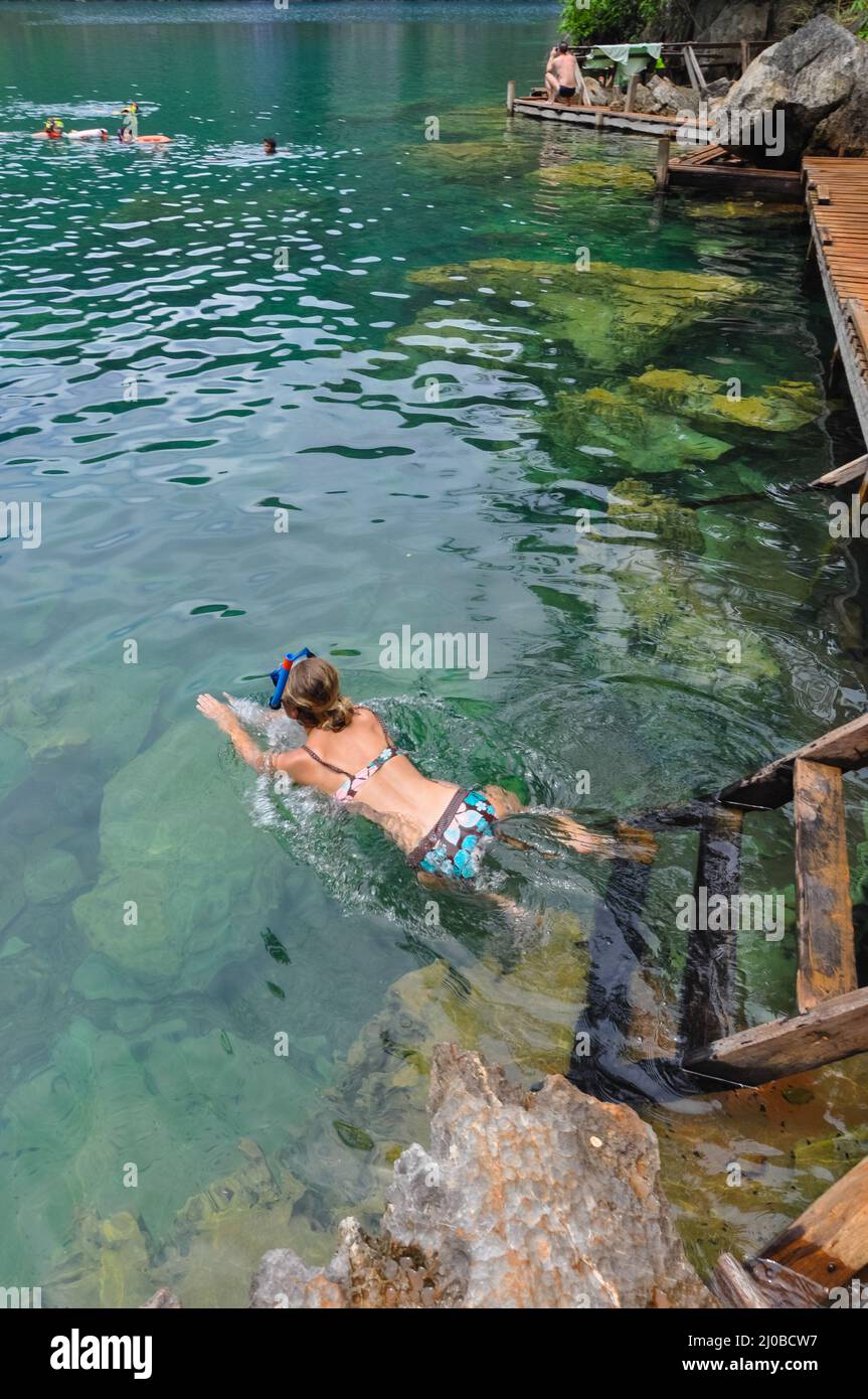 Woman swimming in very Clean and Clear lagoon lake Water next to a ...