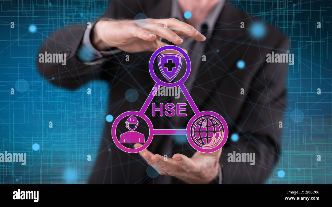 Hse concept between hands of a man in background Stock Photo - Alamy