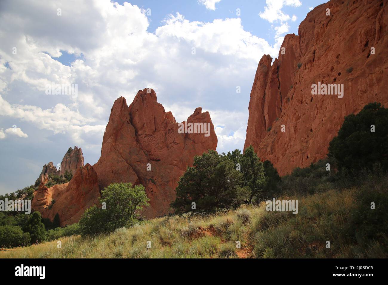Giant red rock formations in a grassfield at the Garden of the Gods ...