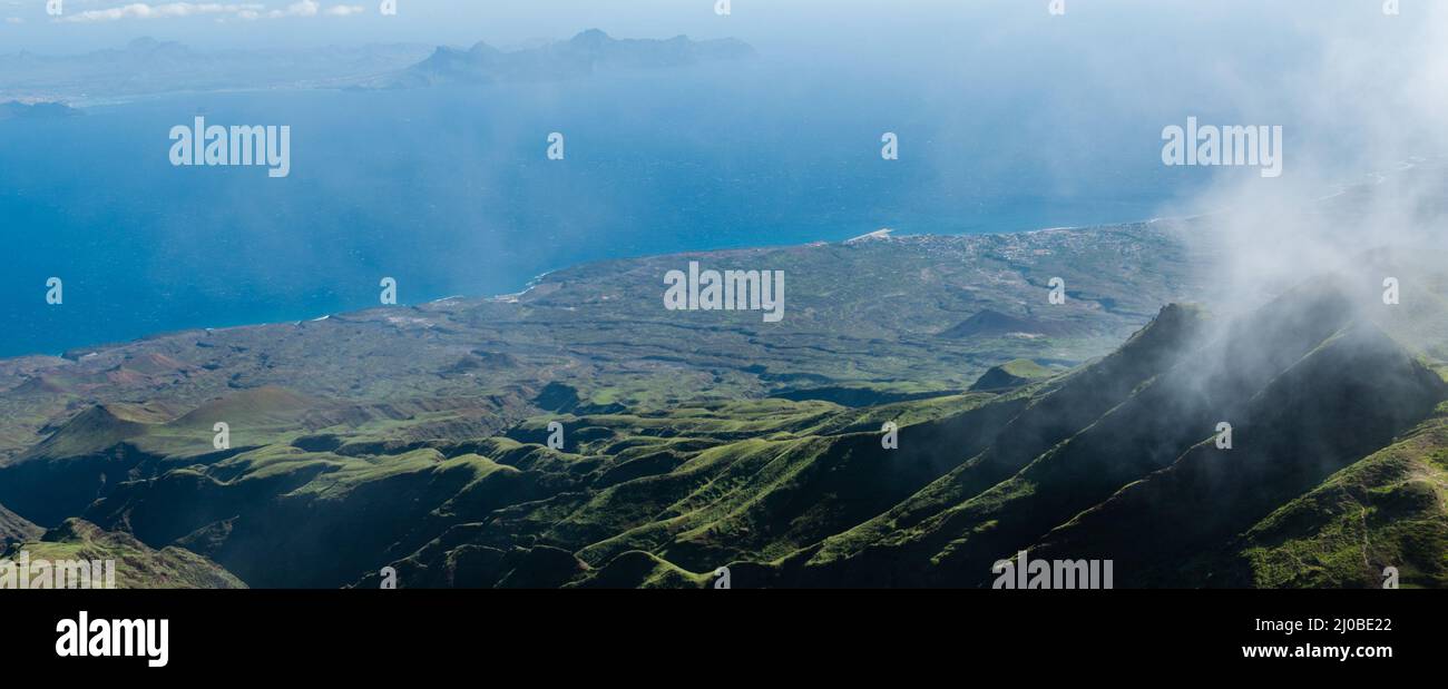 Steep green valley viewpoint leading to blue ocean coast of cape verde ...