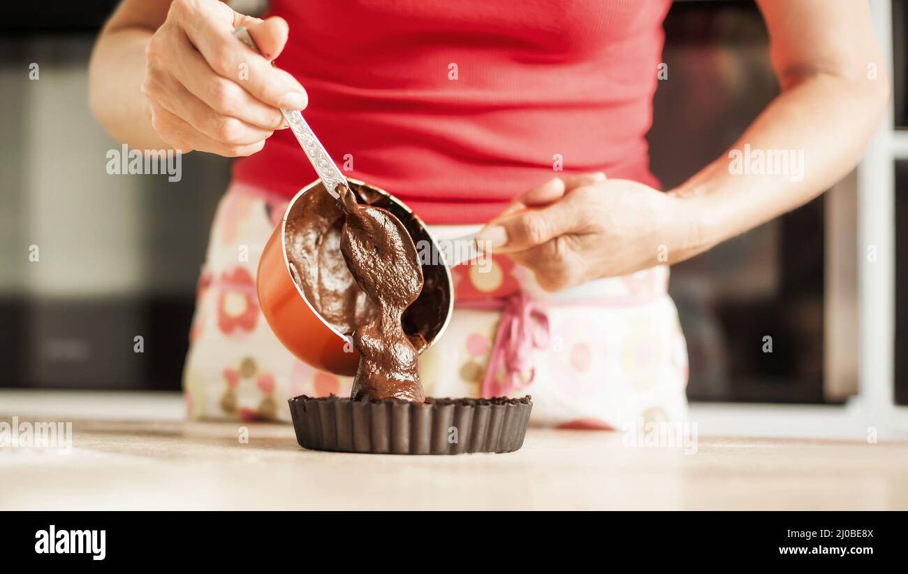 Female chef melted chocolate and preparing sweet cake for dessert ...