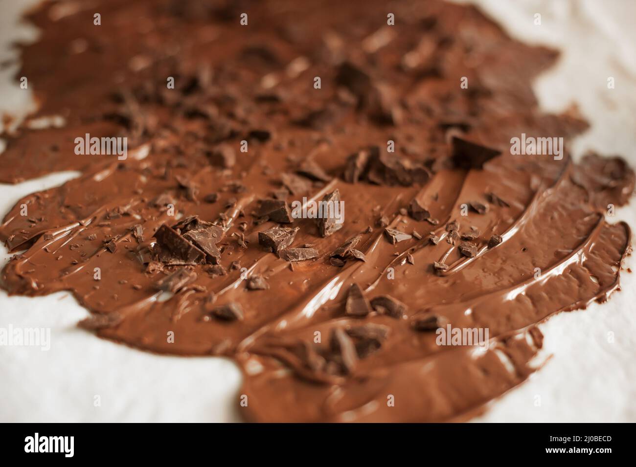 Professional confectioner making tasty cake with melted chocolate ...