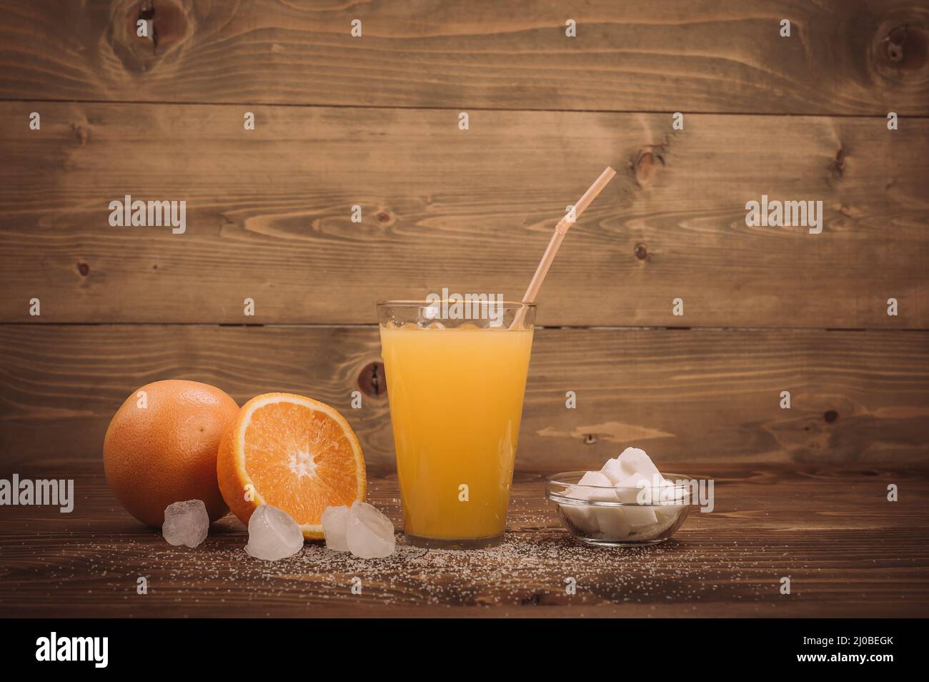 Glass of fresh orange juice with sliced lemon half. Close up Stock ...